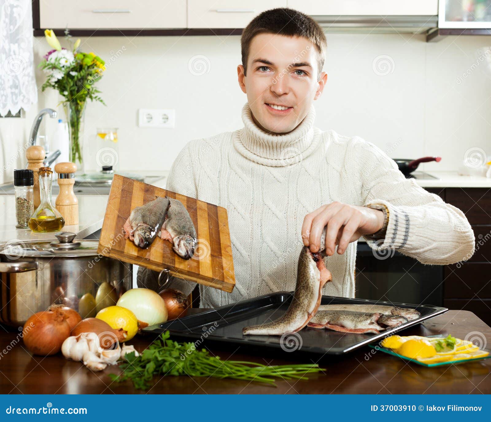 Smiling guy cooking stock photo. Image of freshwater - 37003910