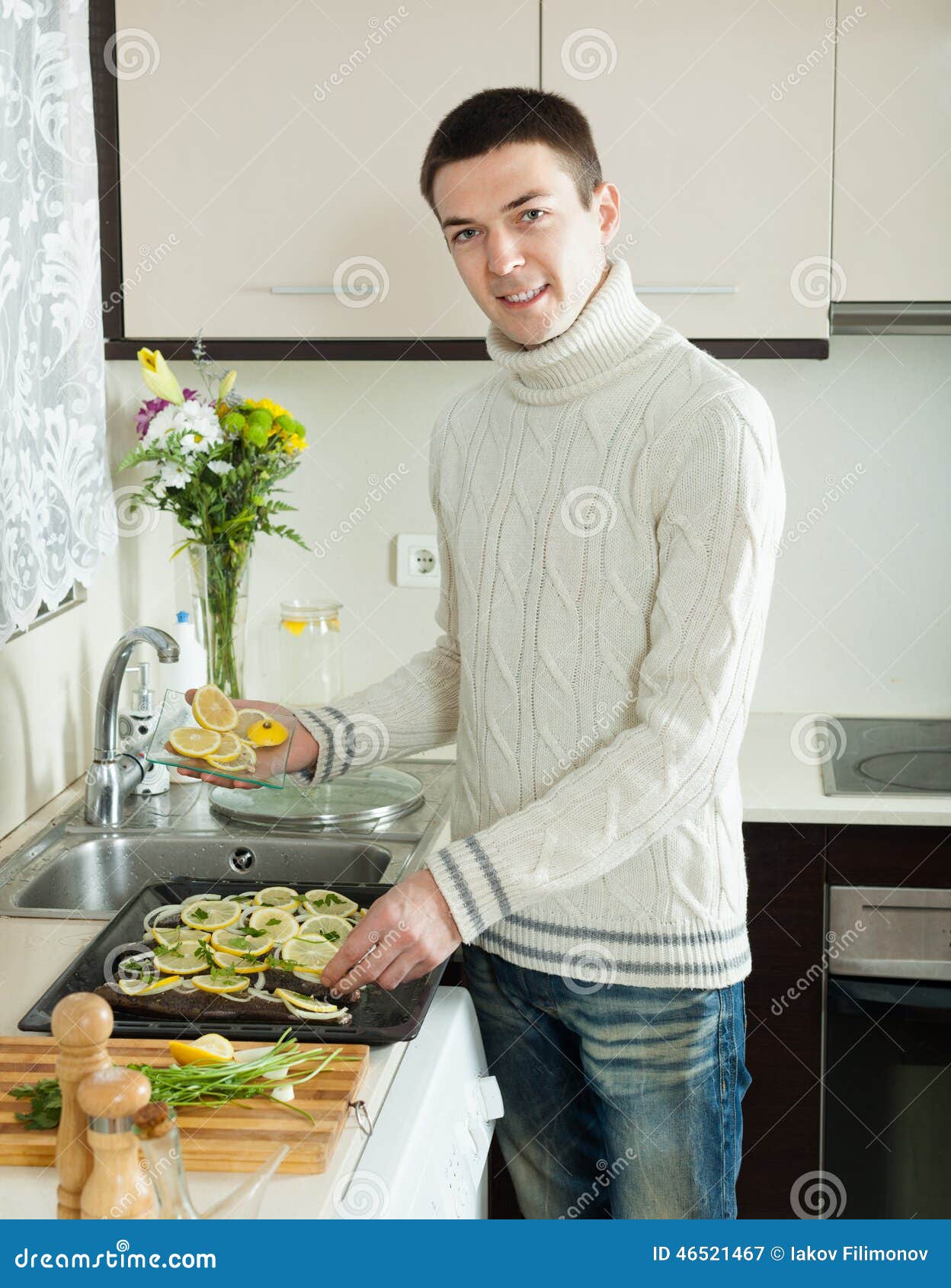 Smiling Guy Cooking Fish with Lemon Stock Image - Image of male, full ...