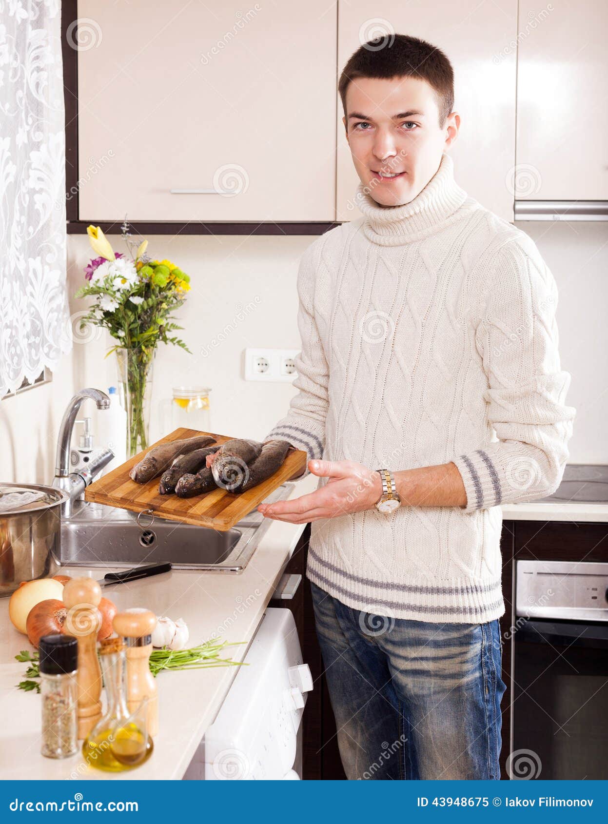 Smiling guy cooking stock image. Image of uncooked, fish - 43948675