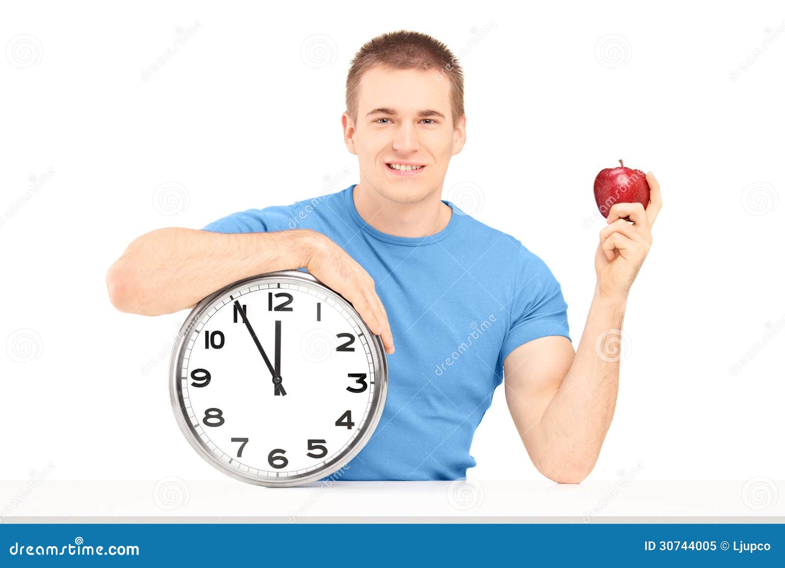 Smiling Guy Holding Wall Clock Red Apple Table Stock Photos - Free ...