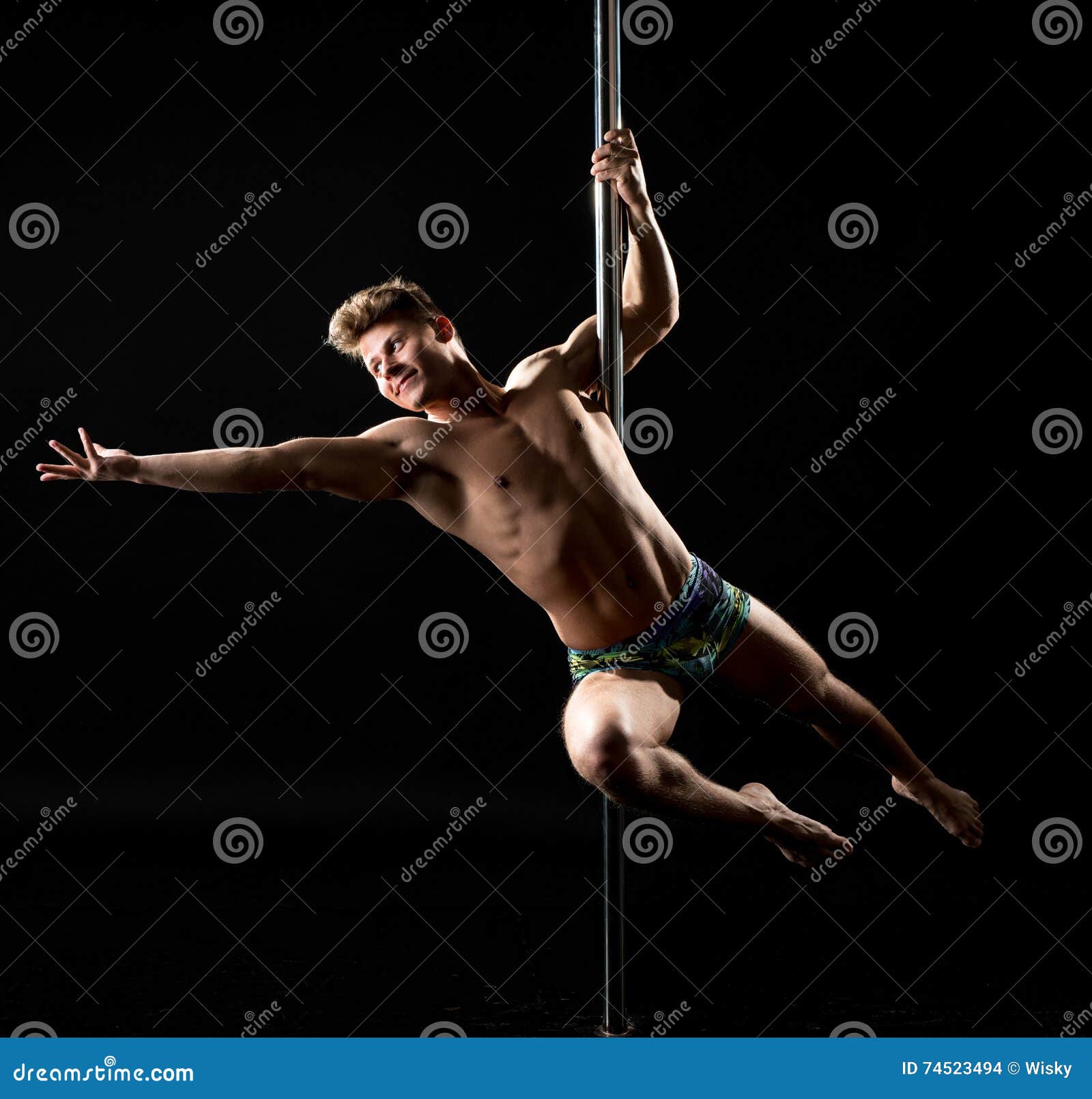 Smiling Guy Posing while Performing Trick on Pole Stock Photo - Image ...