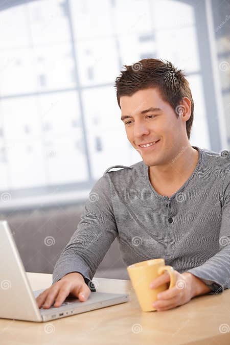 Smiling Guy Using Laptop Computer Stock Photo - Image of adult, indoors ...