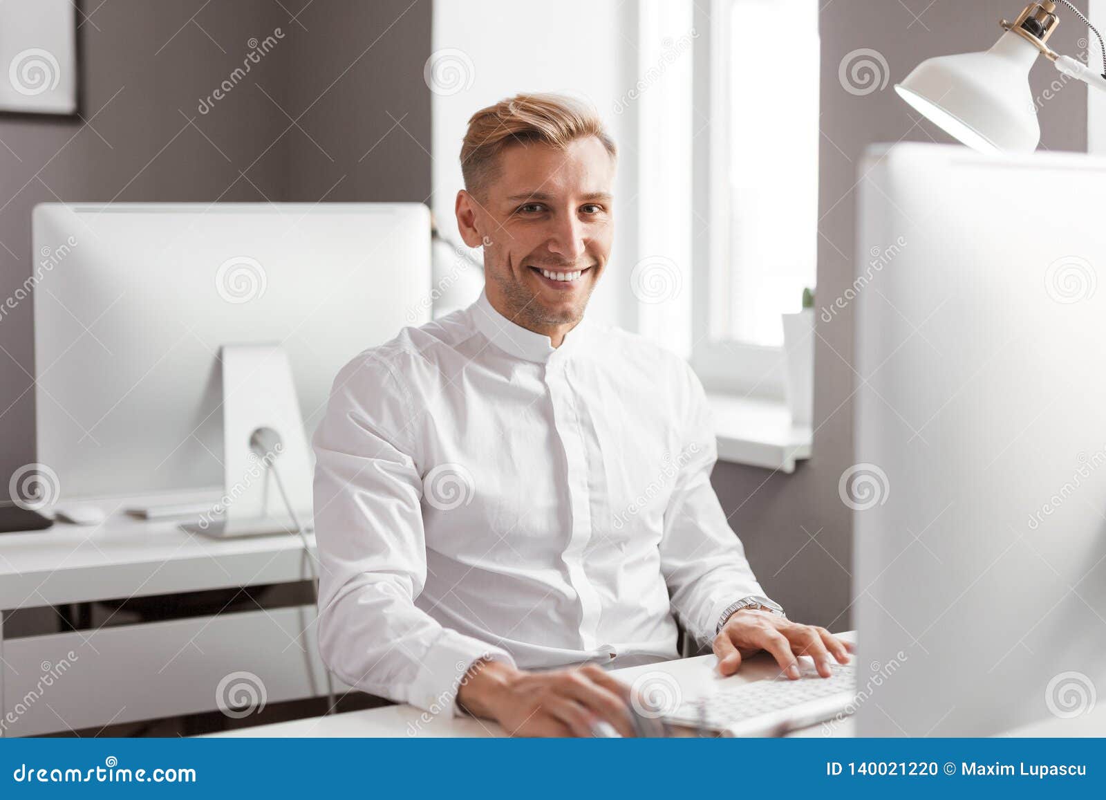 Smiling Guy Working on Computer in Office Stock Photo - Image of device ...