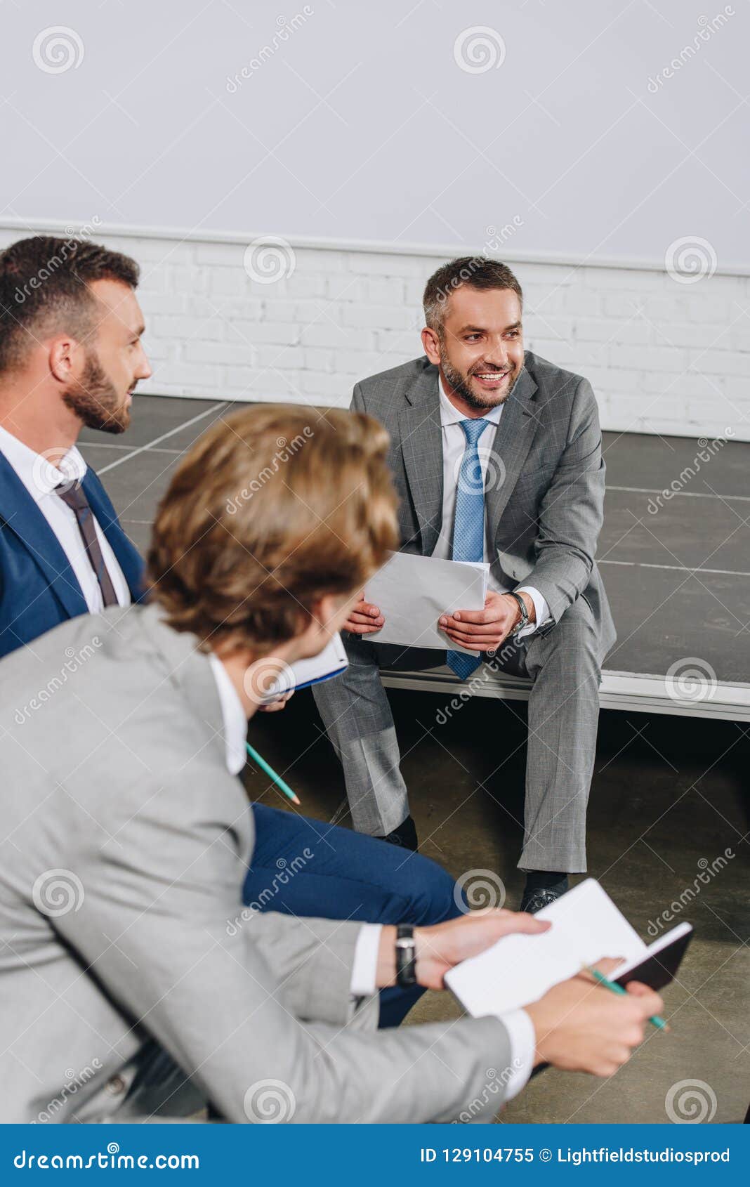 Smiling Handsome Business Coach Looking Away during Training Stock ...