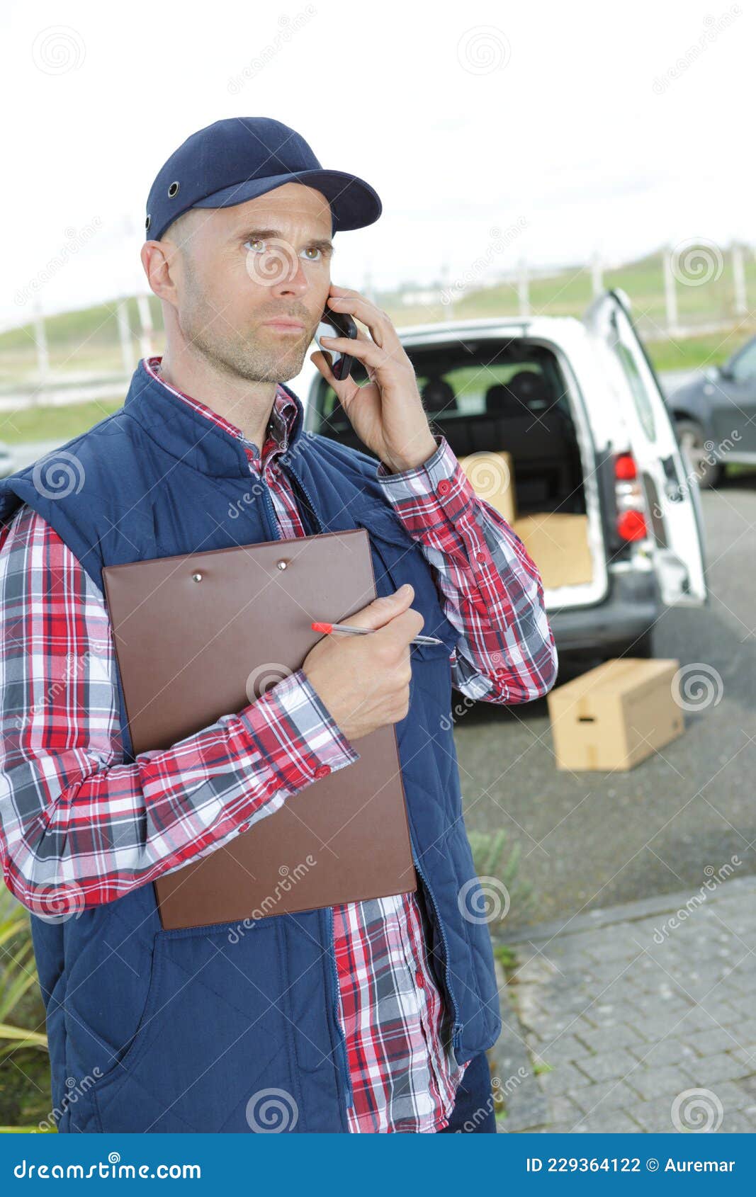 Smiling Handsome Delivery Man Making Call Stock Photo - Image of mail ...