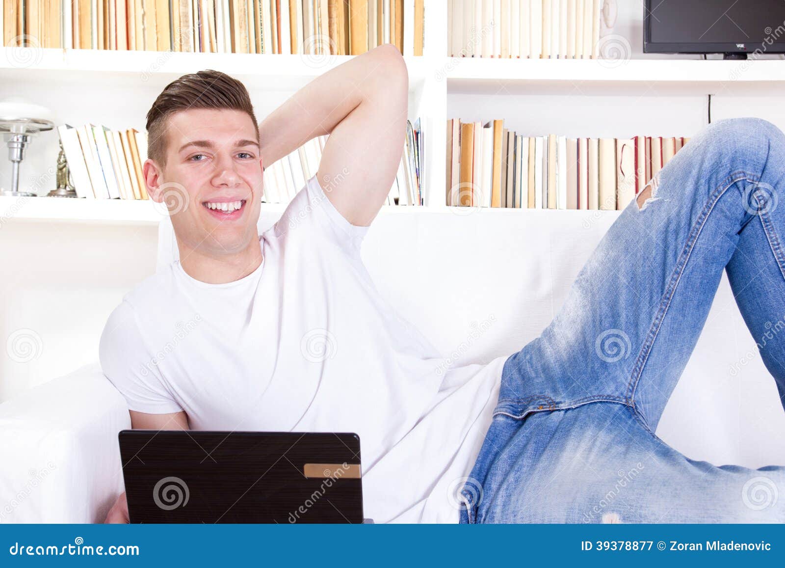 Smiling Handsome Guy Lying on Sofa Using Laptop Computer Stock Image ...