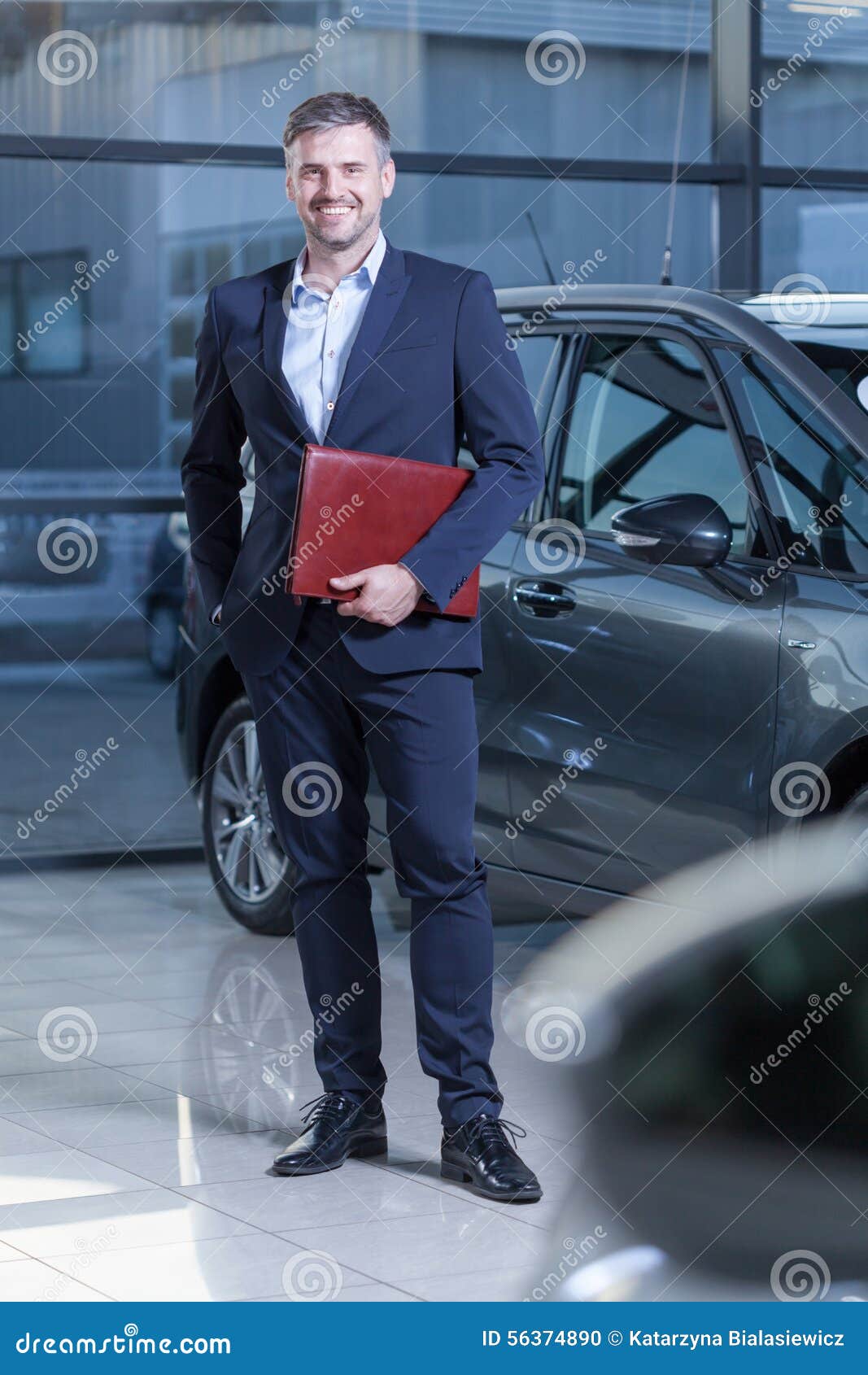 Smiling handsome salesman stock photo. Image of showroom - 56374890