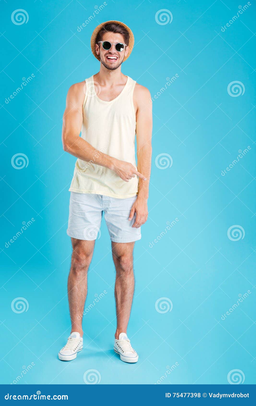 Smiling Handsome Young Man Standing and Pointing Down Stock Photo ...