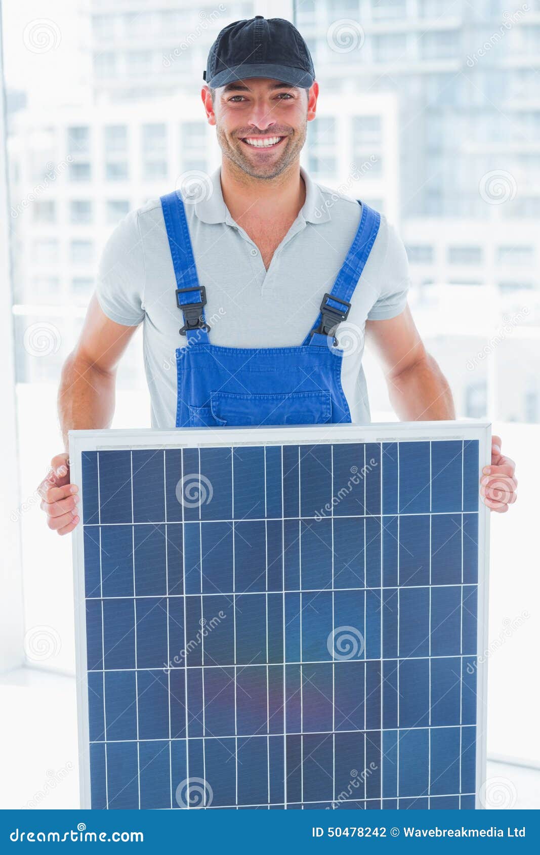 Smiling Handyman Holding Solar Panel in Bright Office Stock Photo ...