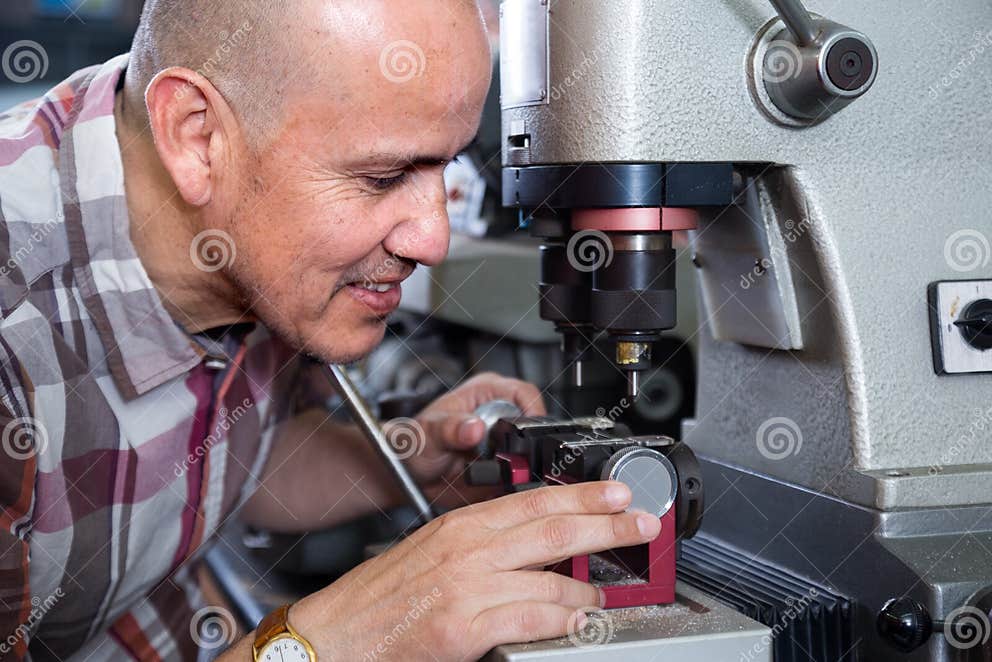 Smiling Handyman Making Duplicates of Door Keys Stock Photo - Image of ...
