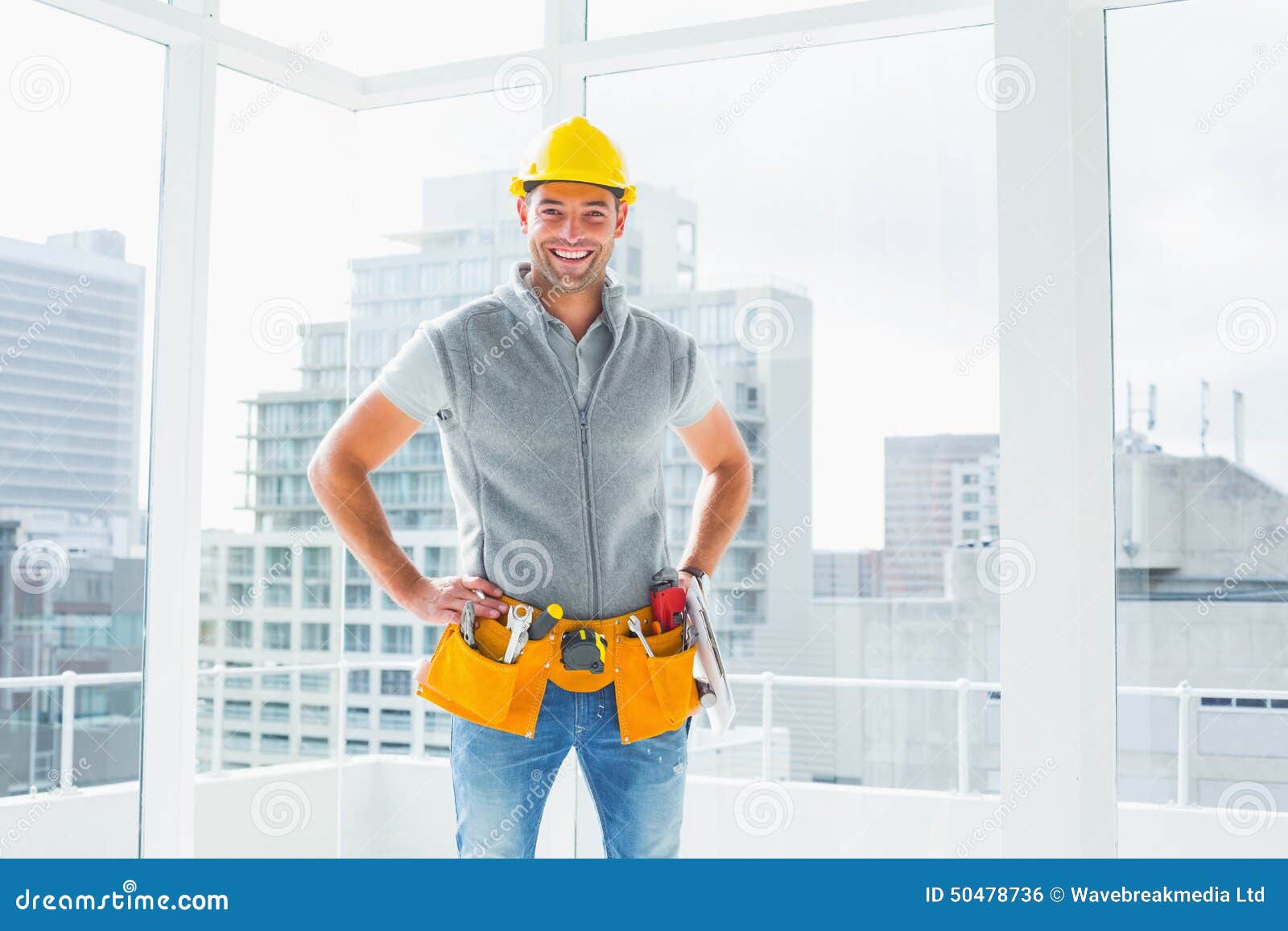 Smiling Handyman Standing in Building Stock Photo - Image of camera ...