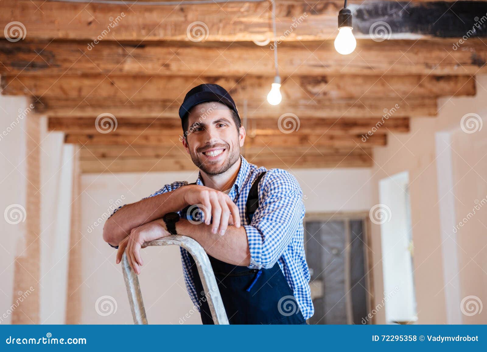 Smiling Handyman Standing on the Ladder Stock Photo - Image of building ...