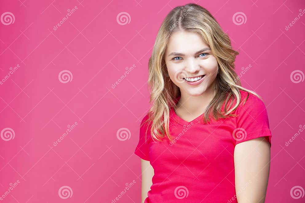 Smiling Happy Winsome Caucasian Blond Girl In Coral T Shirt Posing