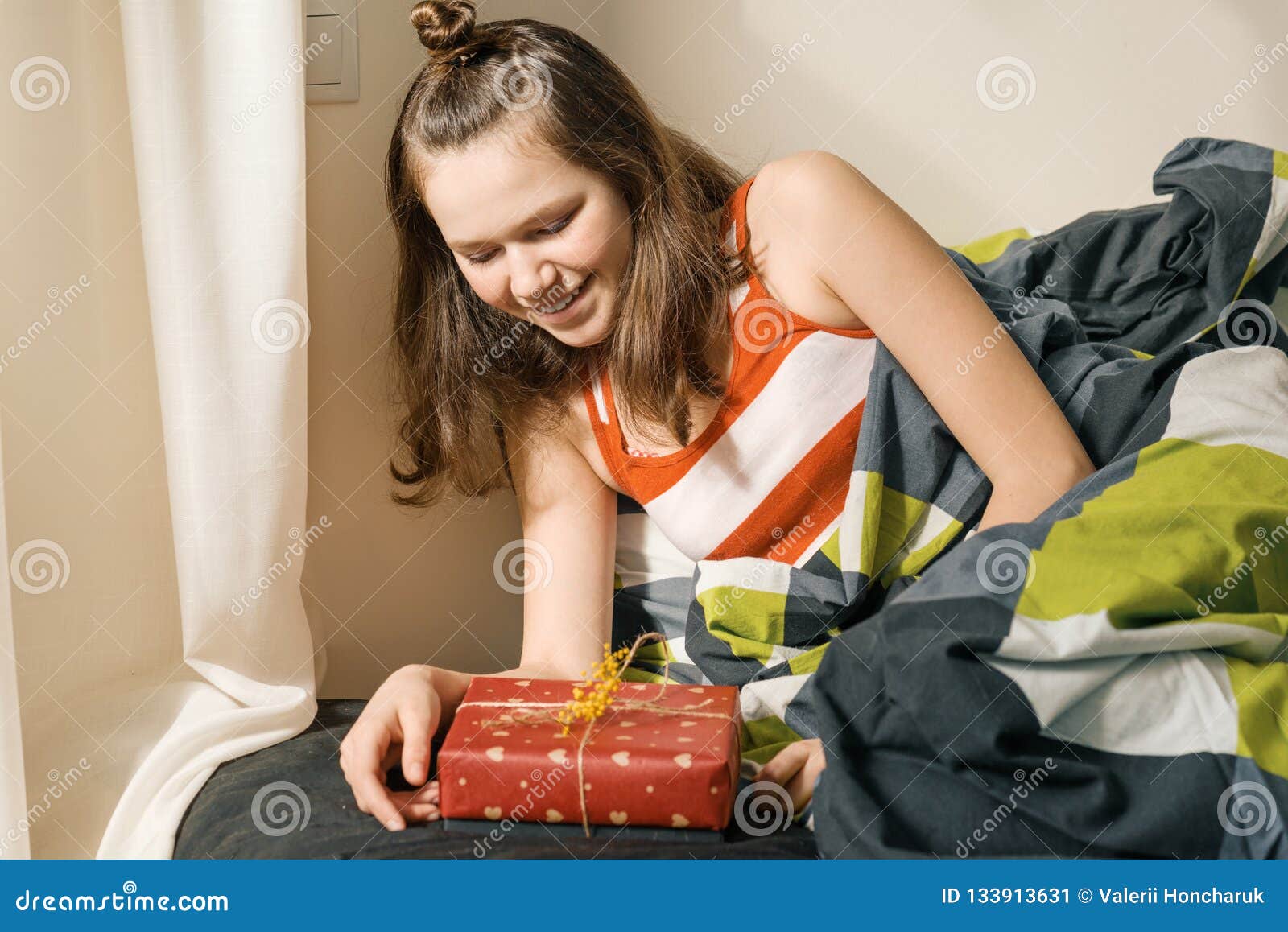 Smiling Happy Young Teen Girl Looking and Opening Surprise Gift in Box ... Smiling Happy Young Teen Girl Looking and Opening Surprise Gift in Box ...