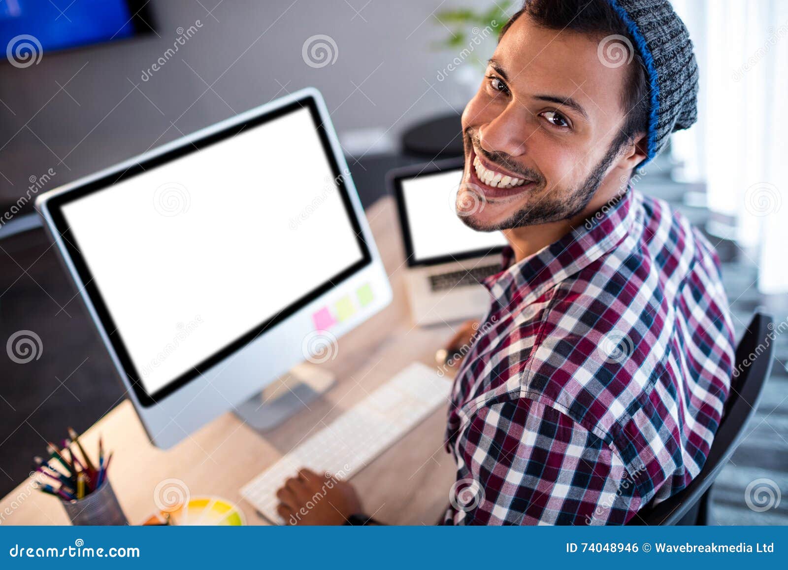 Smiling Hipster Man Posing for Camera while Sitting at Computer Desk ...