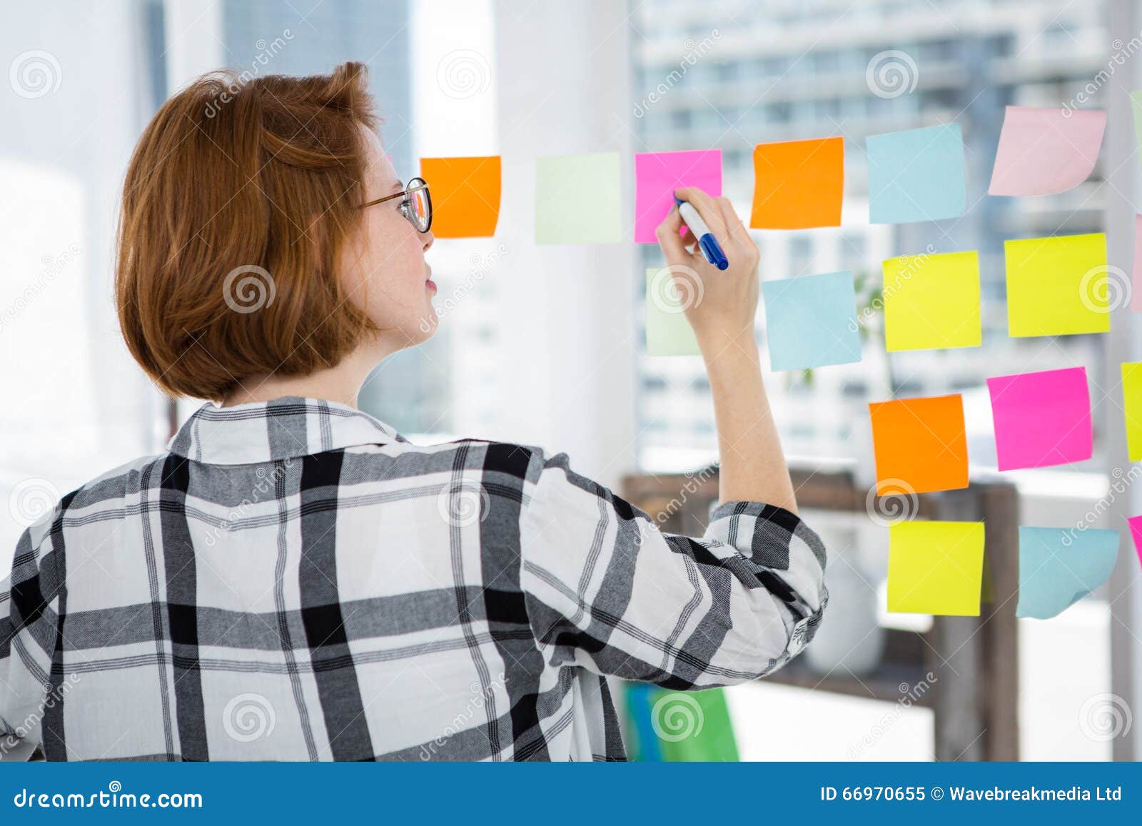 Smiling Hipster Woman Sticking Notes on a Notice Board Stock Image ...