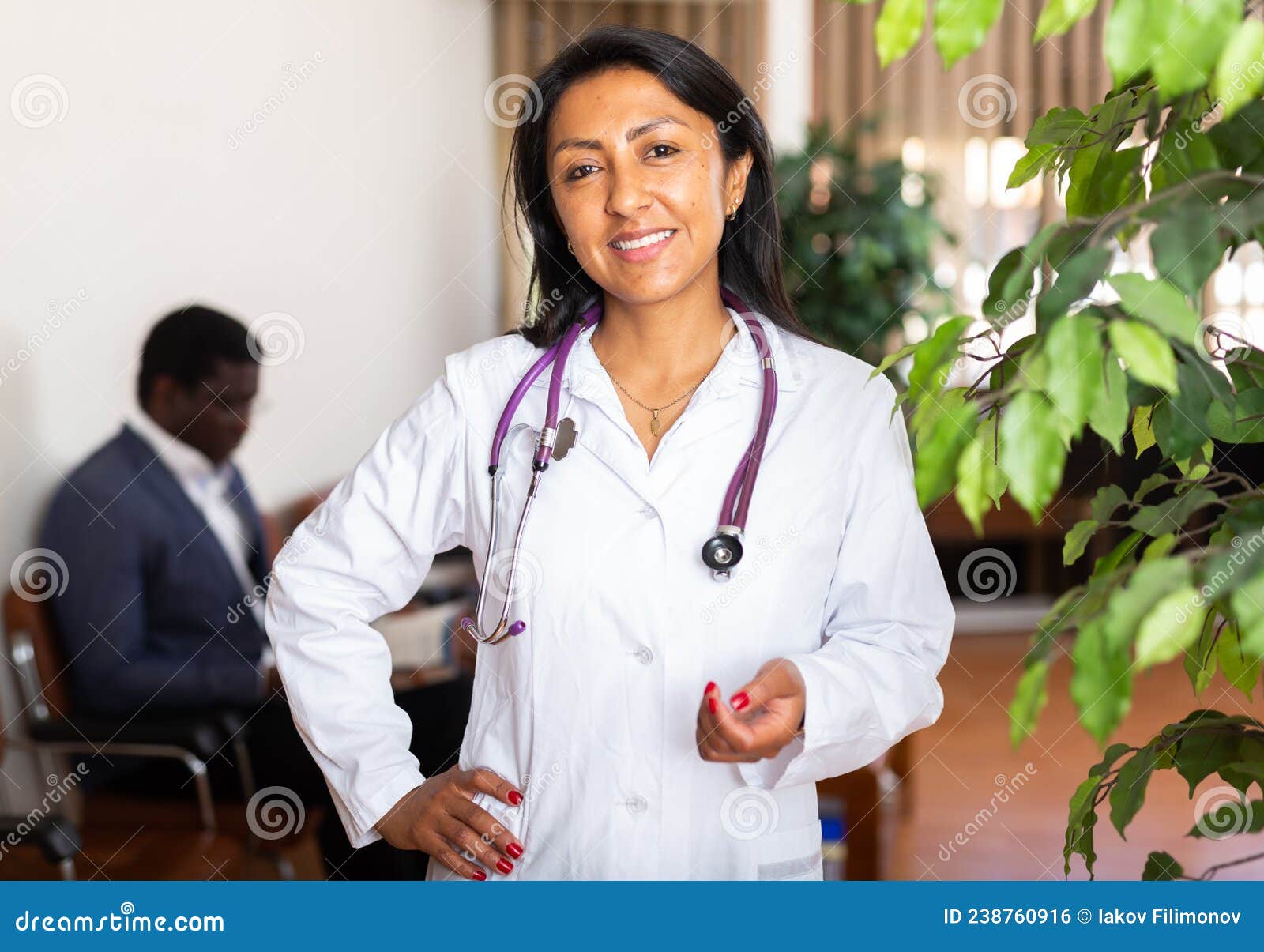 Smiling Hispanic Female Doctor Standing in Medical Office Stock Photo ... Smiling Hispanic Female Doctor Standing in Medical Office Stock Photo ...