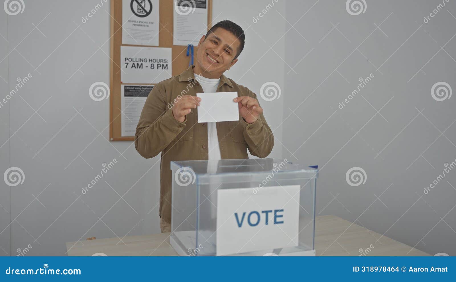 A Smiling Hispanic Man Casting a Ballot in a Voting Booth during an ...