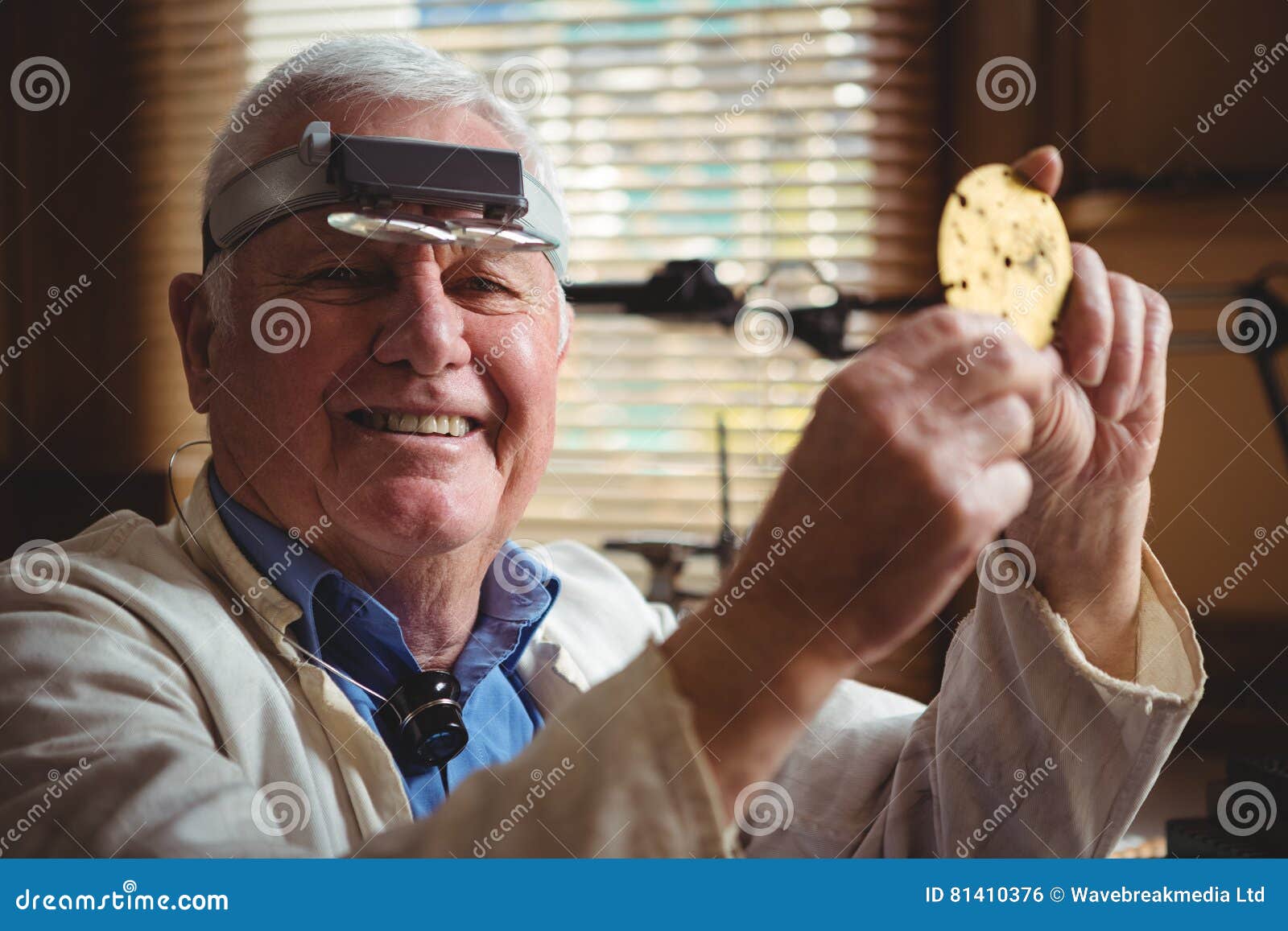 Smiling Horologist Examining Clock Parts in Workshop Stock Photo ...