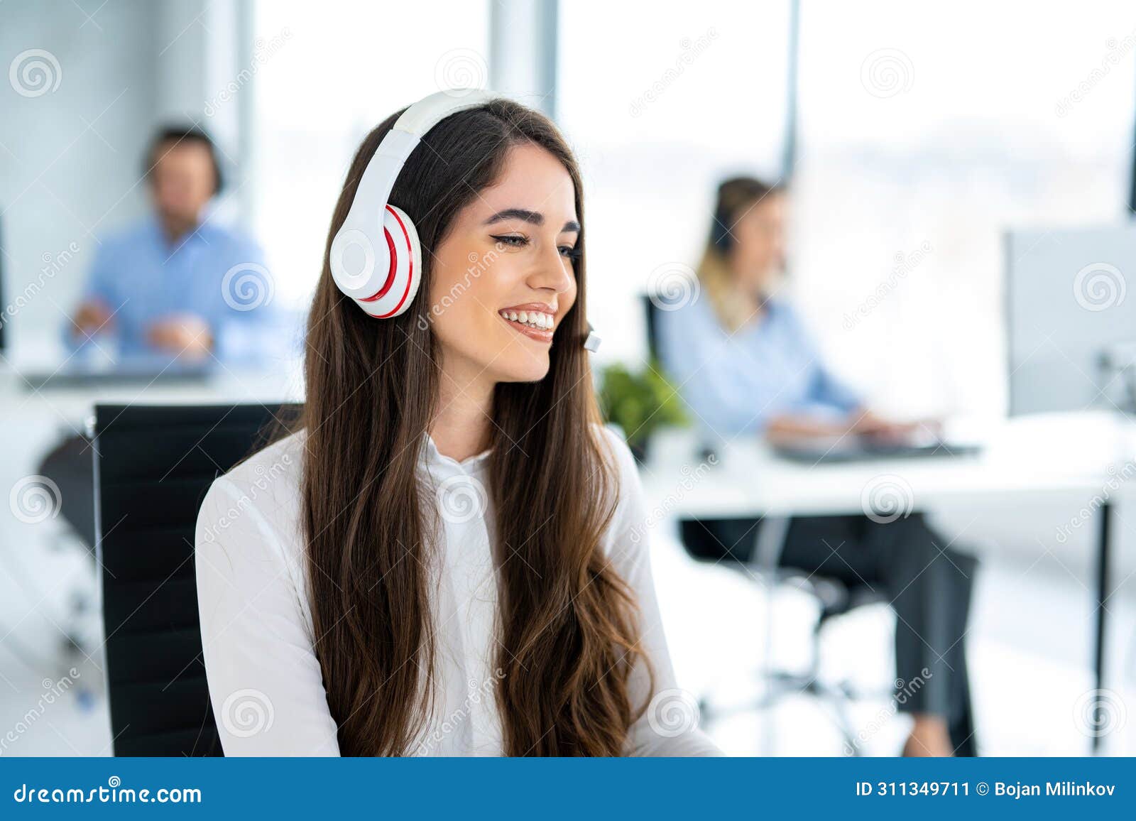 Smiling Hotline Operator Woman with Headset Using Computer in Office ...