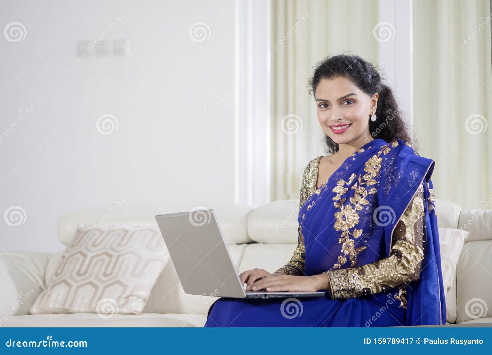 Smiling Indian Woman Using a Laptop at Home Stock Image - Image of ... Smiling Indian Woman Using a Laptop at Home Stock Image - Image of ...