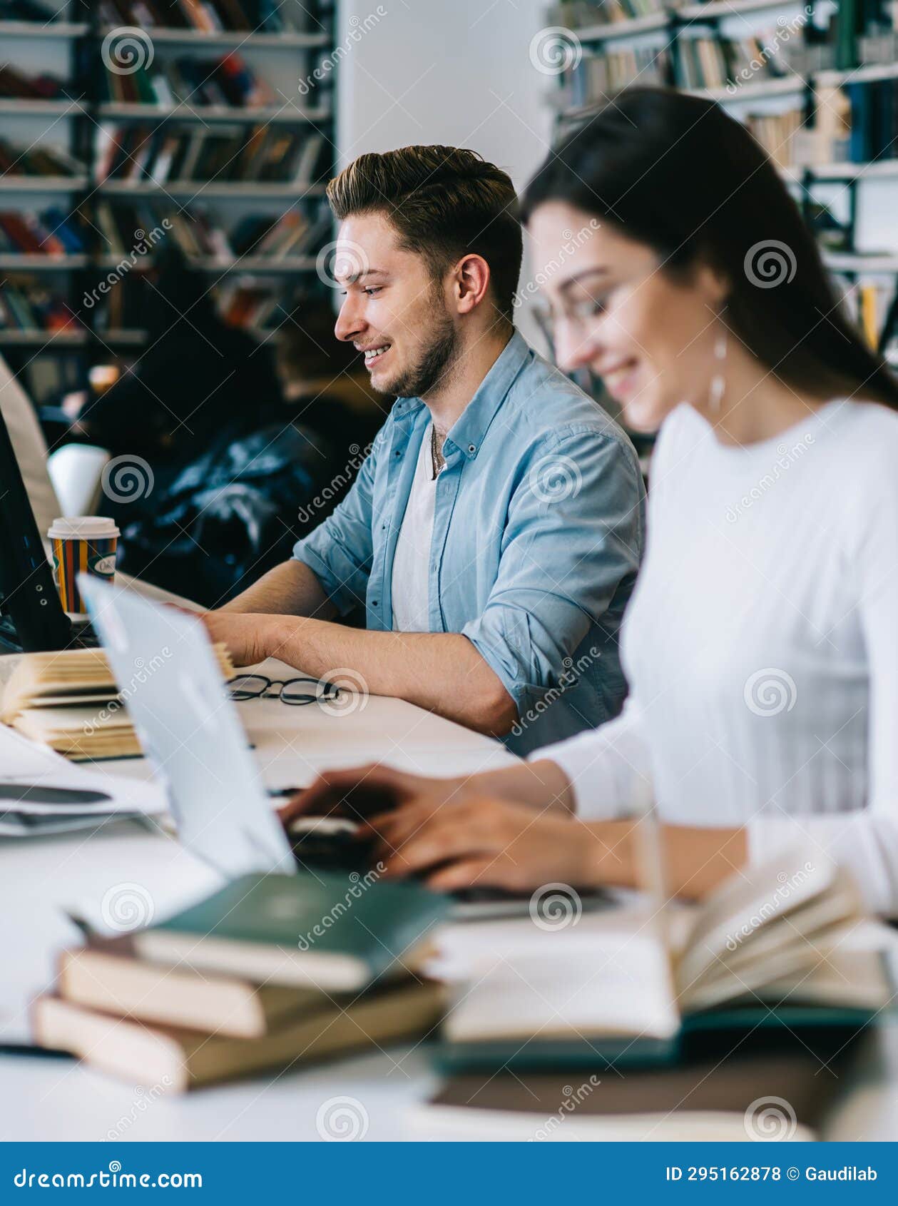 Smiling Intelligent Student Typing on Laptop in Library Stock Photo ...