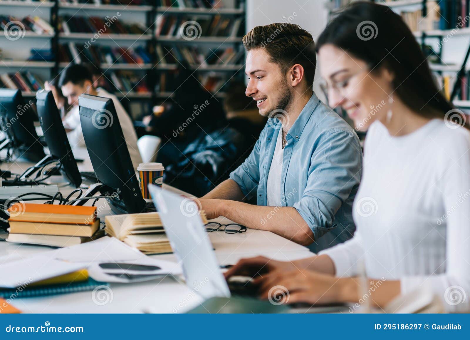 Smiling Intelligent Student Typing on Laptop in Library Stock Image - Image of intelligent ...