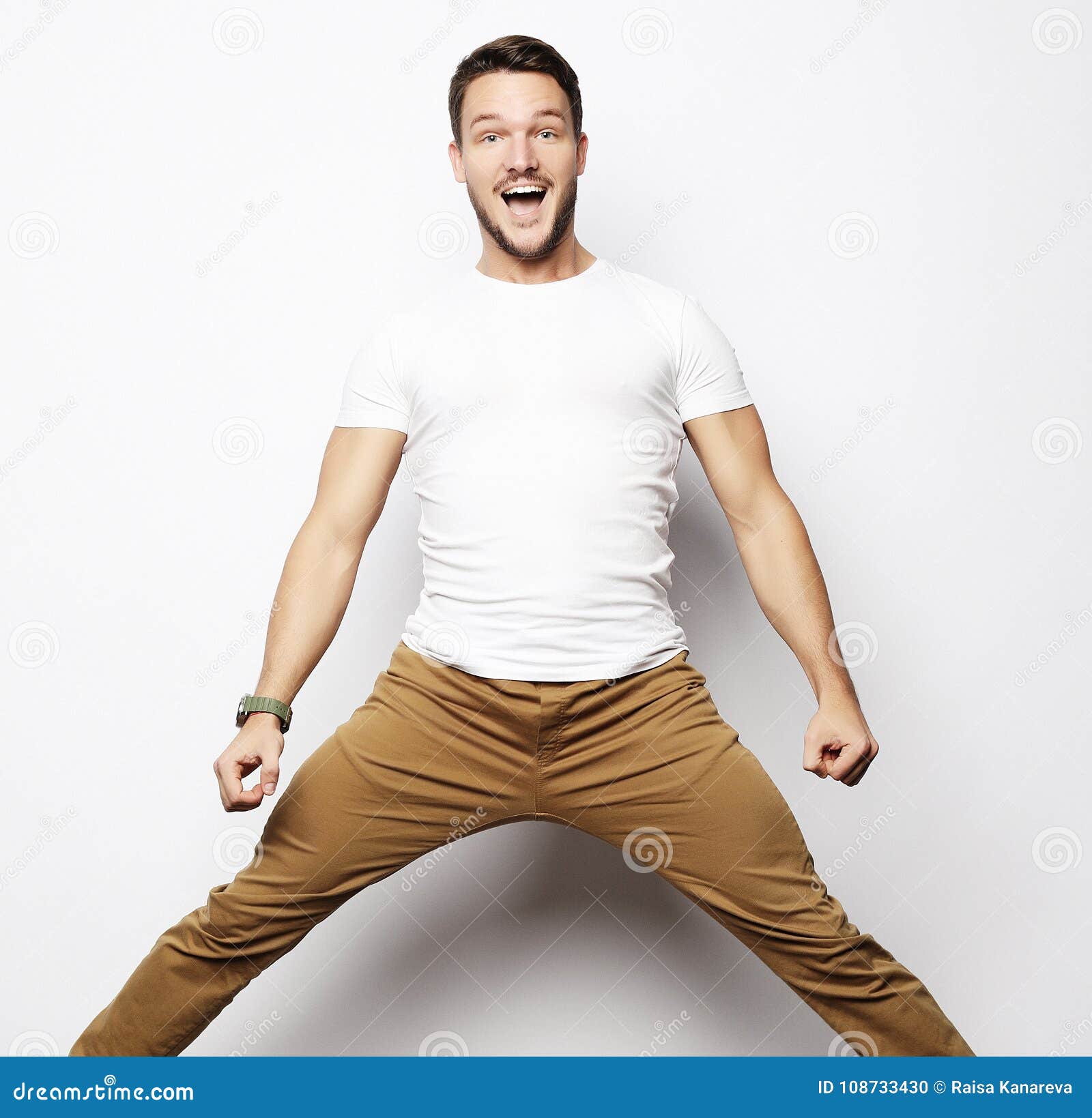Smiling Joyful Man Jumping on a White Background. Stock Photo - Image ...