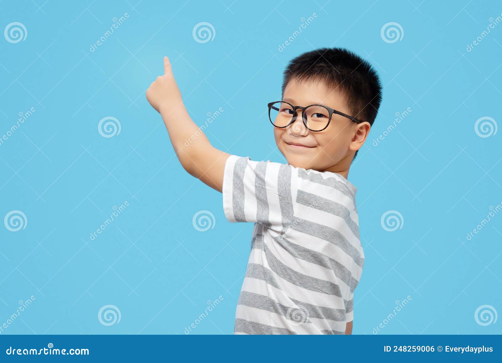 Smiling Kid with Finger Pressing and Pointing Upwards, Back View and ...