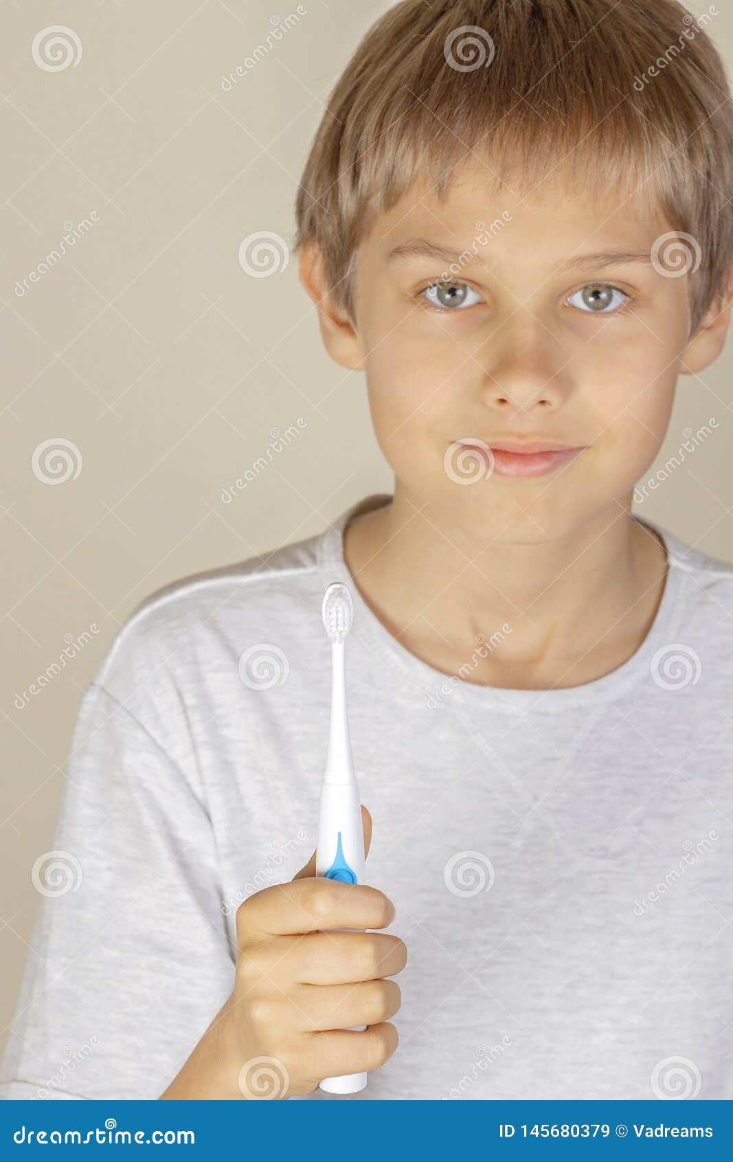 Smiling Kid Holding White Electric Toothbrush Stock Image - Image of ...