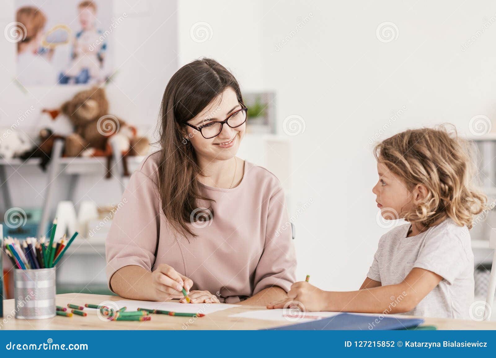 Smiling Language Tutor Working with a Little Boy, Drawing with C Stock ...