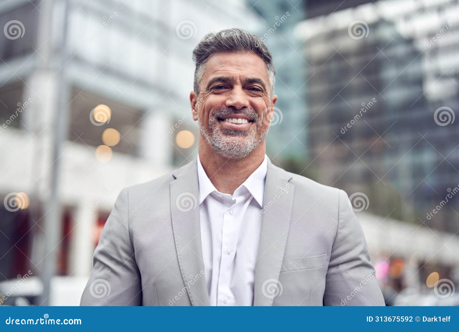 Smiling Latin Mature Business Man Wearing Suit Standing On City Street