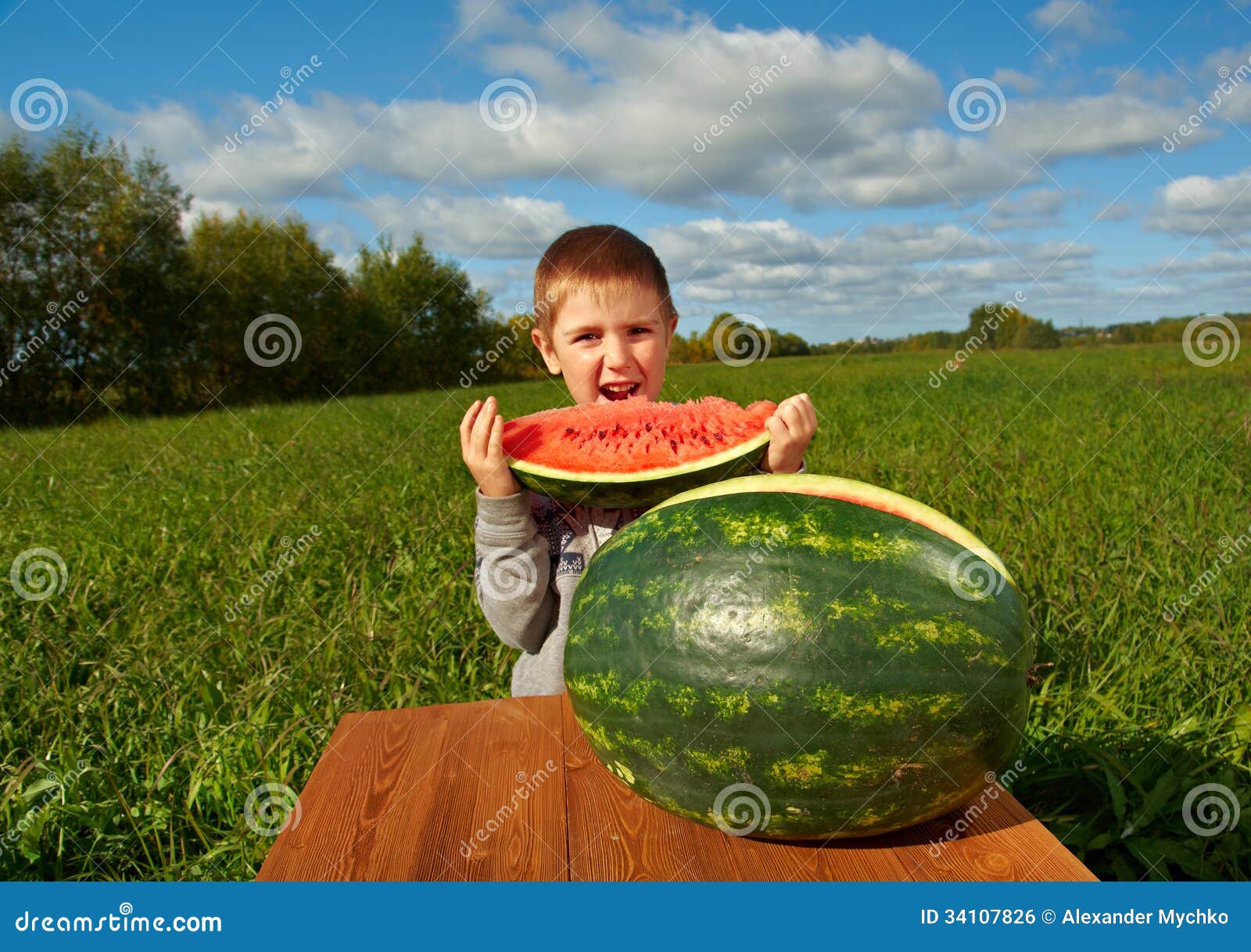 Smiling Little Boy Eating Watermelon Stock Photo - Image of clouds ...