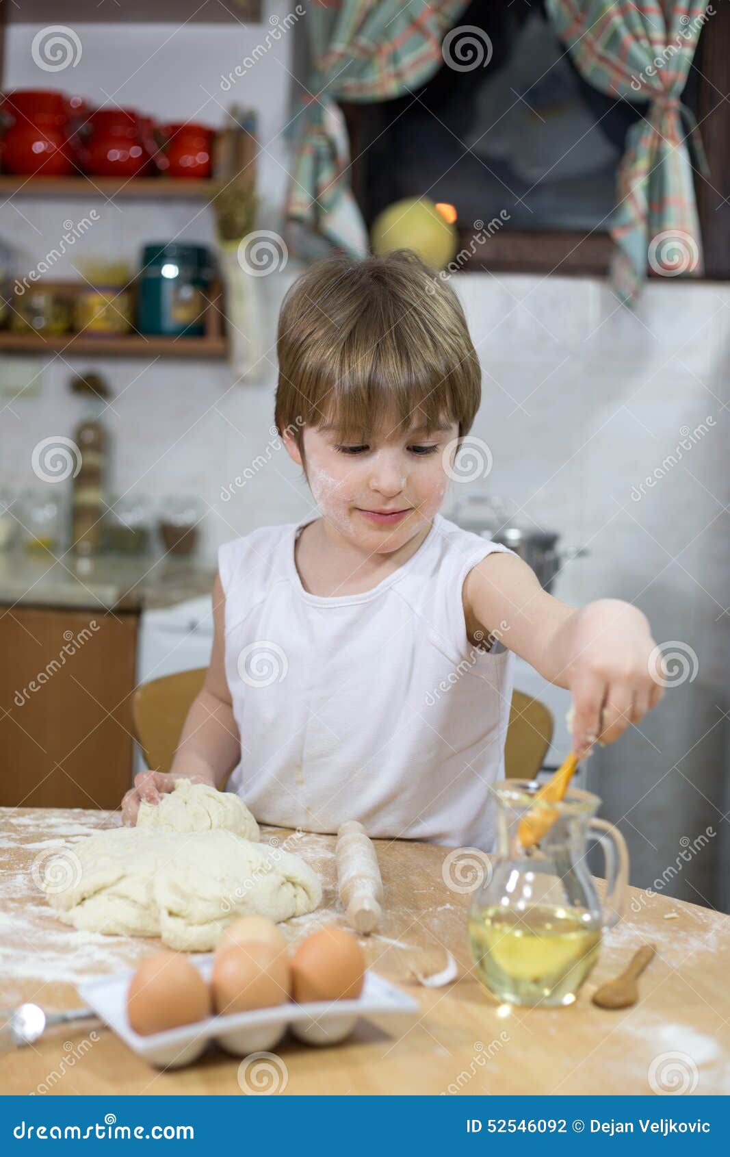 Smiling Little Boy Having Fun Making Dough on the Kitchen Table Stock ...
