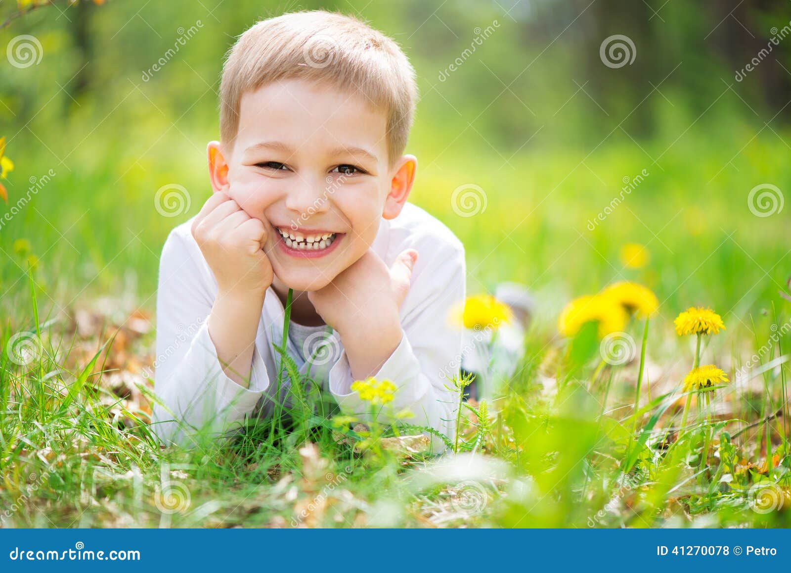 Smiling Little Boy Lying in Green Grass Stock Photo - Image of face ...