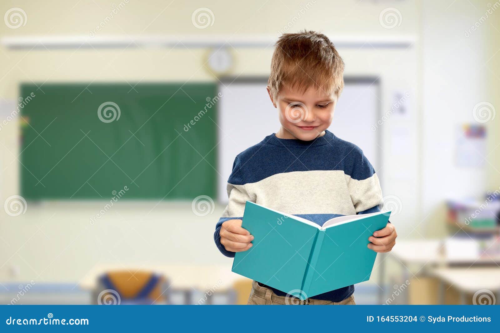 Smiling Little Boy Reading Book at School Stock Photo - Image of ...