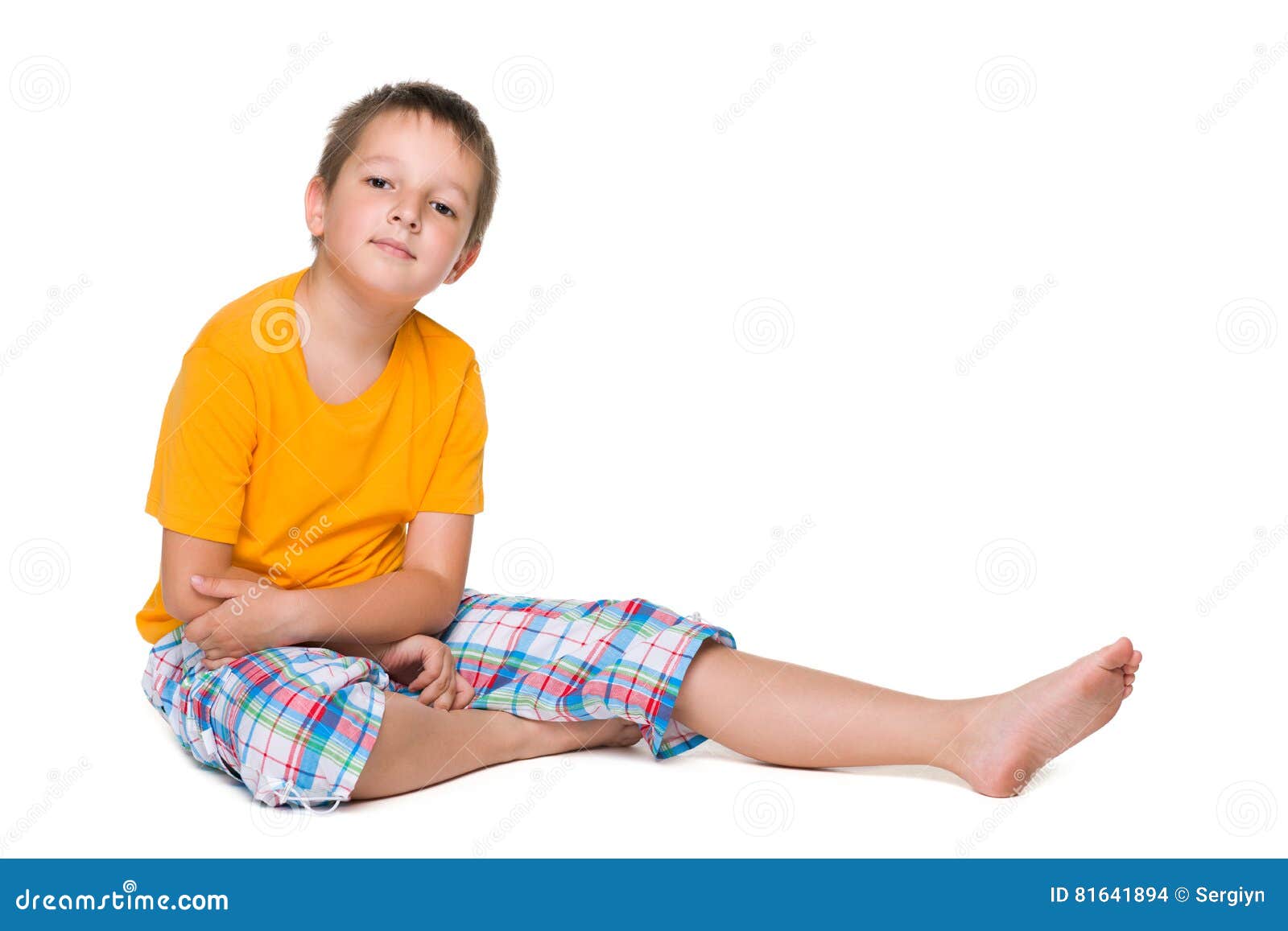 Smiling little boy sits stock photo. Image of childhood - 81641894