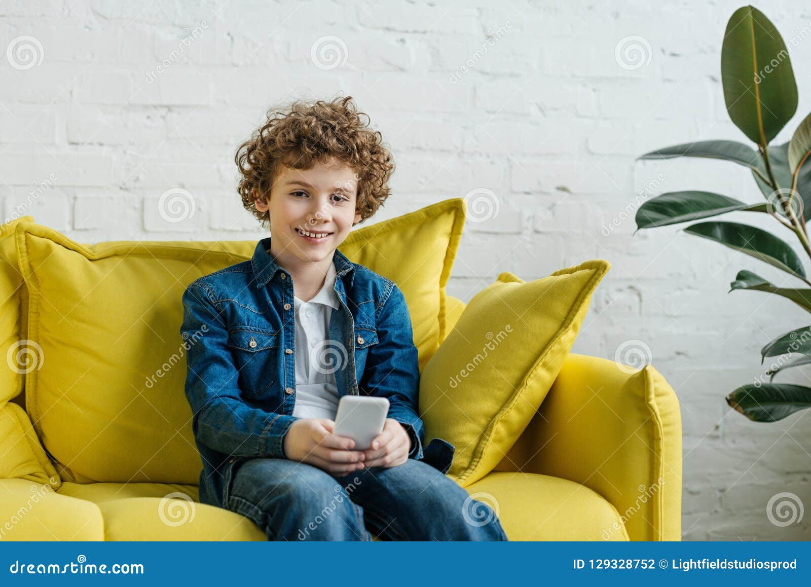 Smiling Little Boy Using Phone Sitting Stock Photo - Image of wireless ...