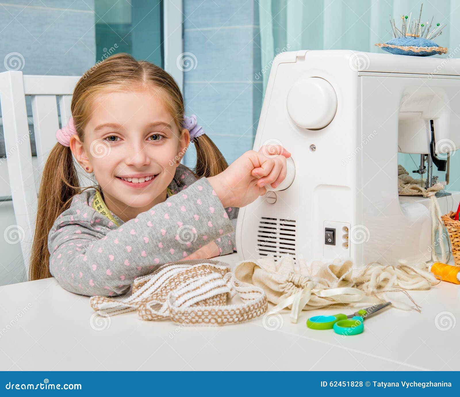 Smiling Little Girl at the Table with Sewing Stock Photo - Image of ...