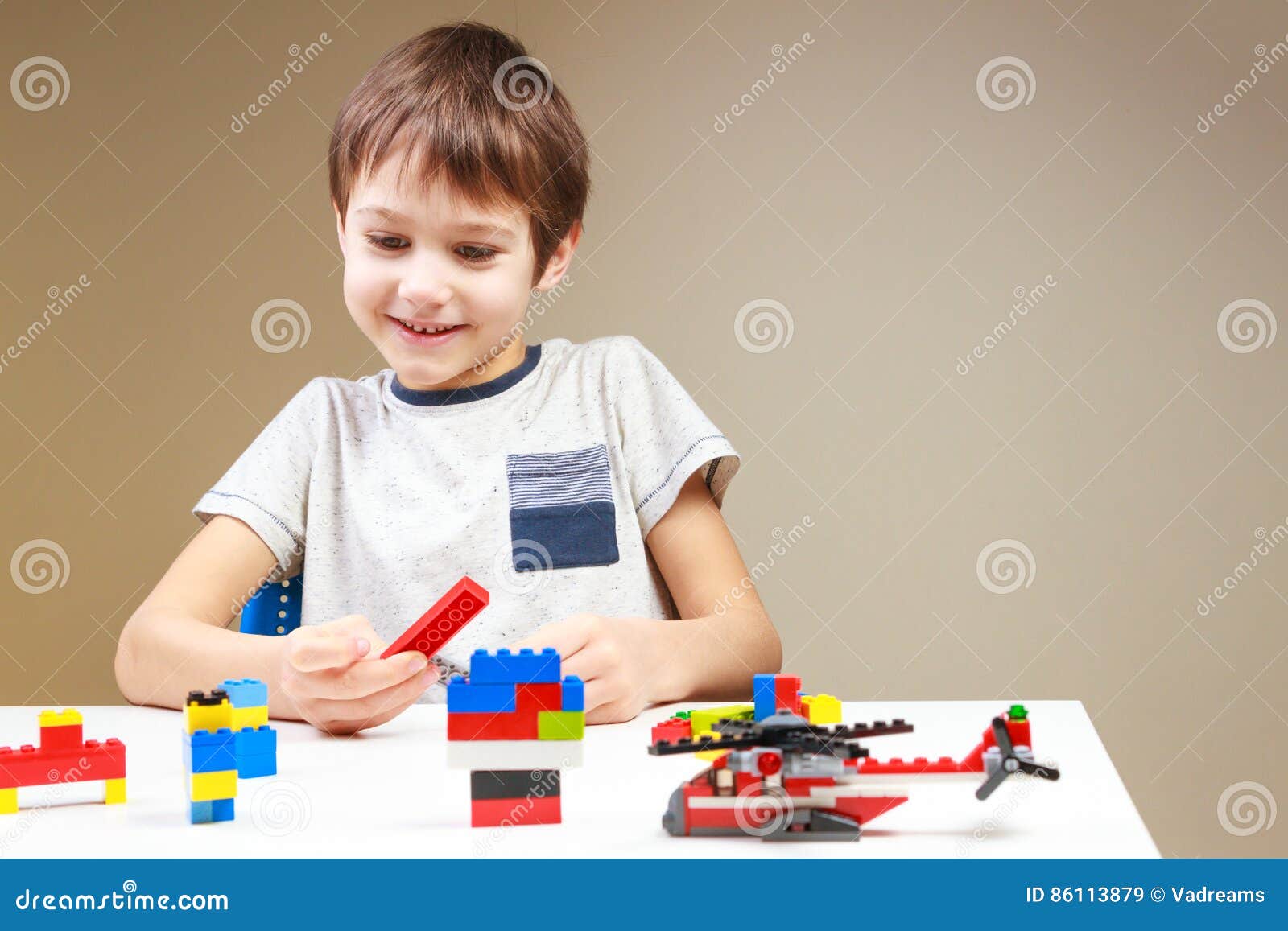 Smiling Little Kid Playing with Colorful Plastic Construction Bricks at ...