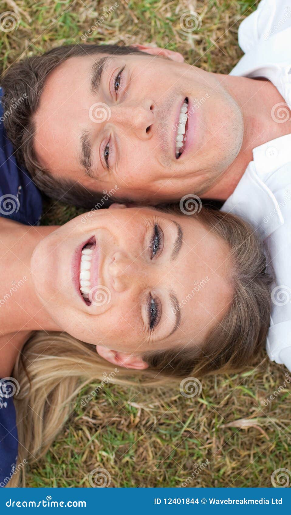 Smiling Lovers Lying on the Grass Stock Photo - Image of happiness ...