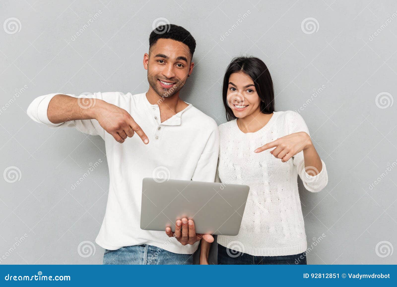 Smiling Loving Couple Using Laptop Computer and Pointing. Stock Image ...