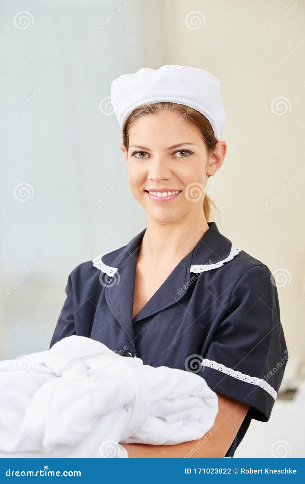 Smiling maid in uniform stock photo. Image of cleaning - 171023822