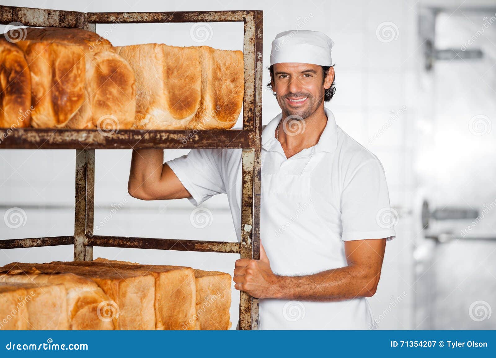 Smiling Male Baker Standing by Bread Rack Stock Image - Image of brown ...