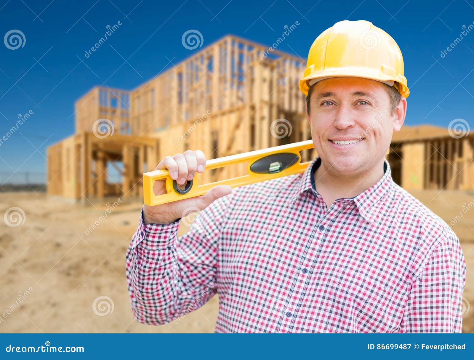 Smiling Male Contractor in Hardhat Holding Blueprints and Level Stock ...