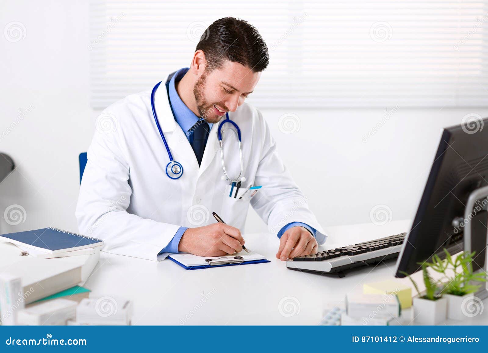 Smiling Male Doctor Writing Notes Stock Photo - Image of clinic ...