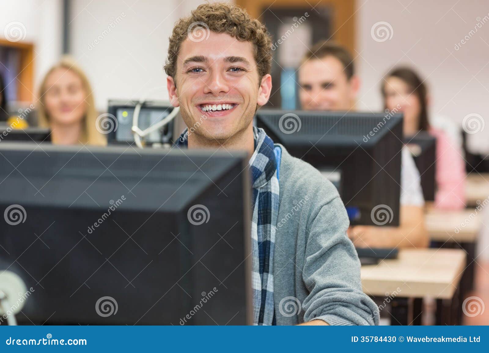 Smiling Male Student with Others in Computer Room Stock Photo - Image ...