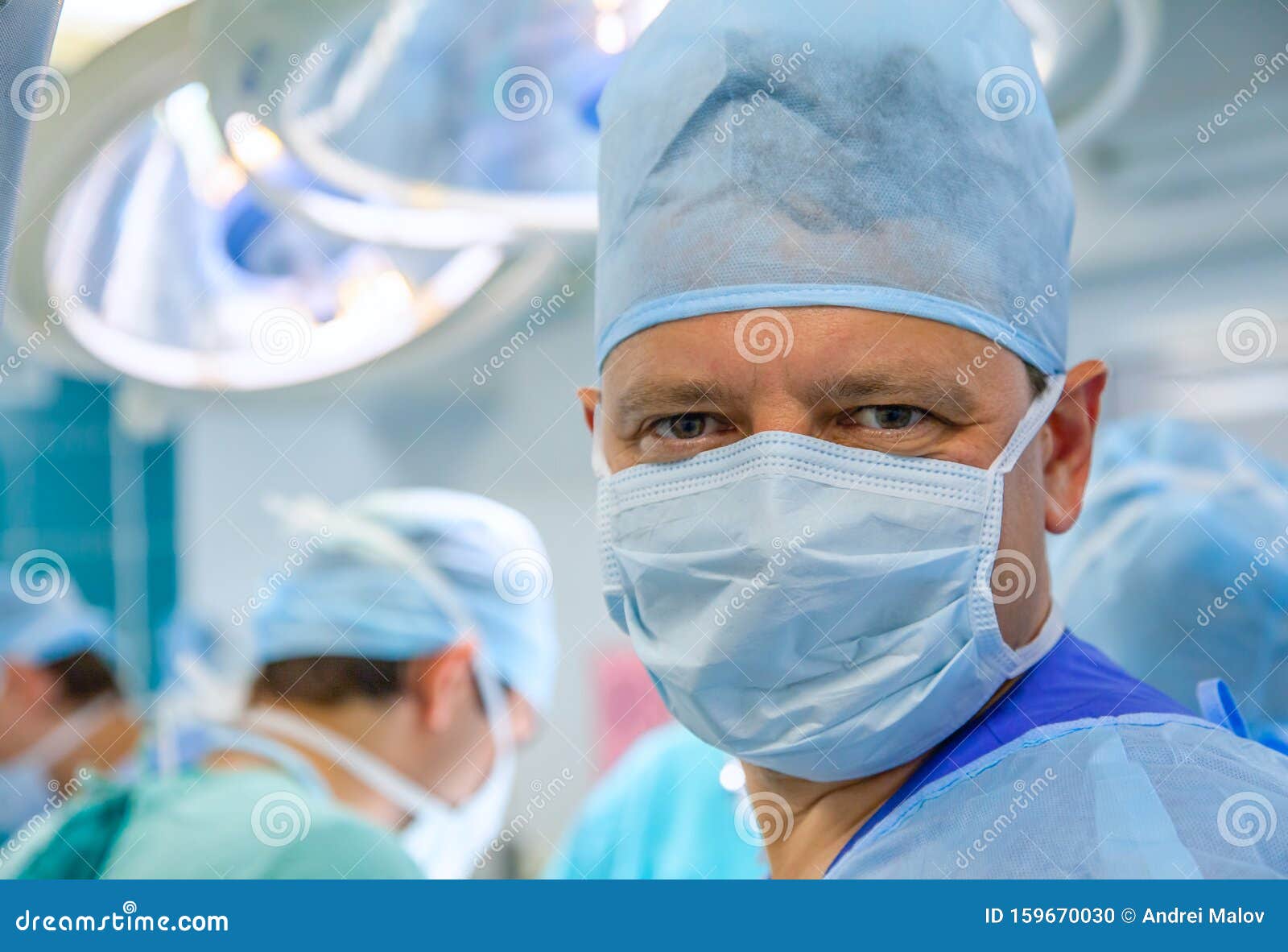 Smiling Male Surgeon in Uniform with Mask in Surgery Room Stock Photo ...