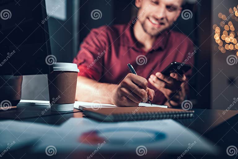 Smiling Male Worker is Using Mobile Phone at Work Stock Image - Image ...