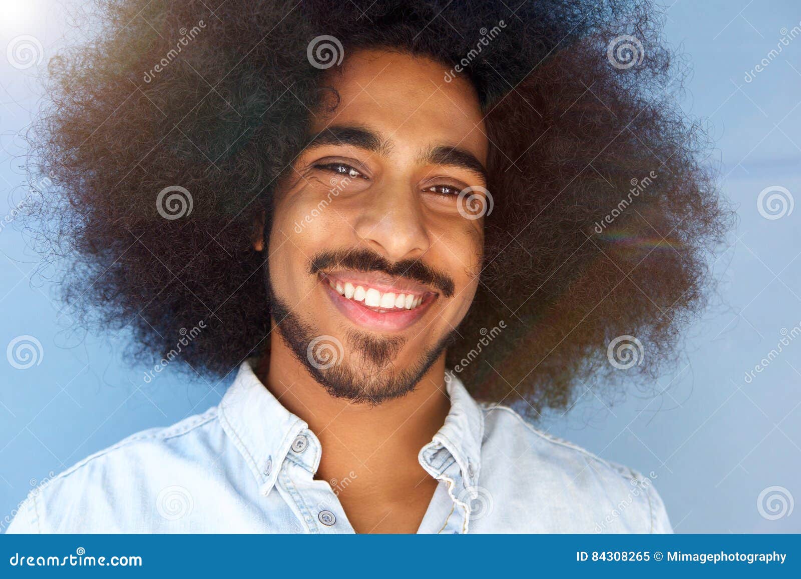 Smiling Man with Afro and Beard by Blue Wall Stock Image - Image of ...